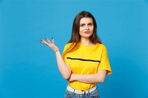 당황 하 게 자극 된 젊은 여자의 초상화 카메라를 찾고 생생한 캐주얼 복장에 스튜디오에서 밝은 파란색 벽 배경에 고립 된 손을 확산 사람들 라이프 스타일 개념입니다 복사