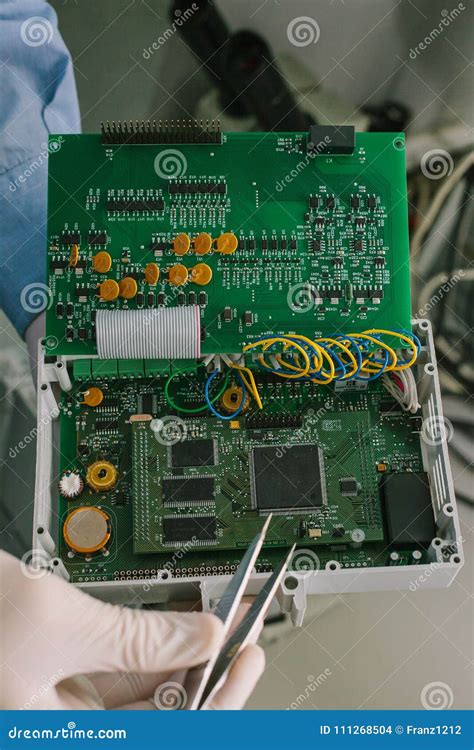 Computer Expert Professional Technician Examining Board Computer In A Laboratory In A Factory