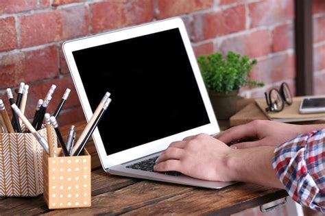 Premium Photo Man Working On Laptop At Table
