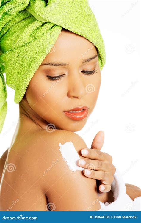 Attractive Woman Rubbing A Body Lotion On Her Arm Side View Stock