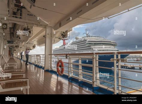 Photographer On Promenade Deck Of Ruby Princess Cruise Ship Photographing Carnival Glory And