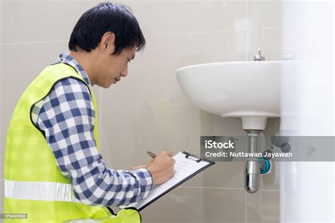 검사관 또는 엔지니어는 체크리스트를 사용하여 건설 및 품질 보증 새 집을 검사하고 있습니다 엔지니어 또는 건축가 또는 접촉자는