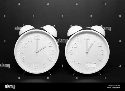 Daylight Saving Time Concept Two White Retro Clock Isolated On Black Background Copy Space