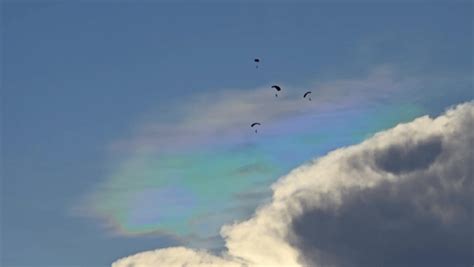 Iridescent Rainbow Clouds Provide Backdrop For Spore Red Lions