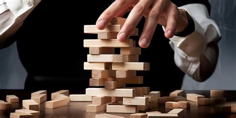 Premium Ai Image A Person Stacking Wooden Blocks On A Table