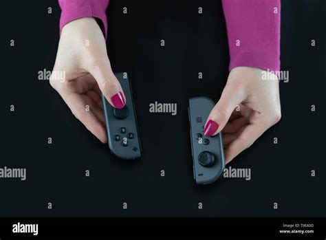 HEGGENES FEBRUARY Top View Of Woman Hands Holding Nintendo Switch Gaming Controllers For