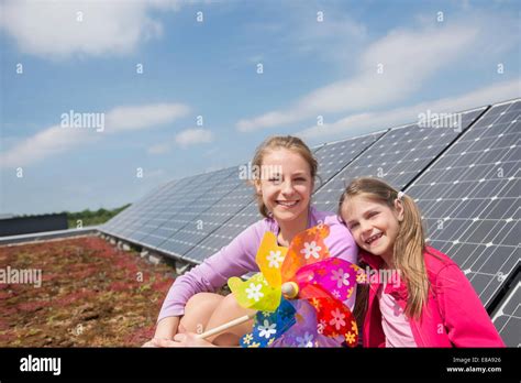 Two Girls Sitting Next To Photovoltaic Panel Stock Photo Alamy