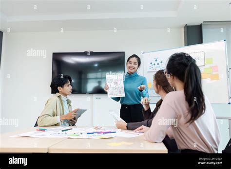 Team Collaborating On Ux Ui Design In Modern Office With Whiteboard And Digital Devices Stock
