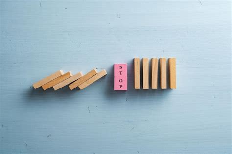 Premium Photo Word Stop On A Stack Of Pink Wooden Blocks Interrupting