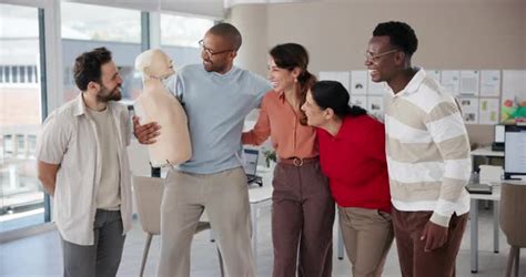 Teamwork Laughing And Cpr With People In Workshop For Support