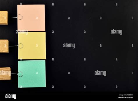 List Three Paper Notes With Holder On Black For Presentation Stock