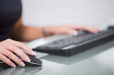 Premium Photo Woman Using Computer Mouse And Keyboard At Desk