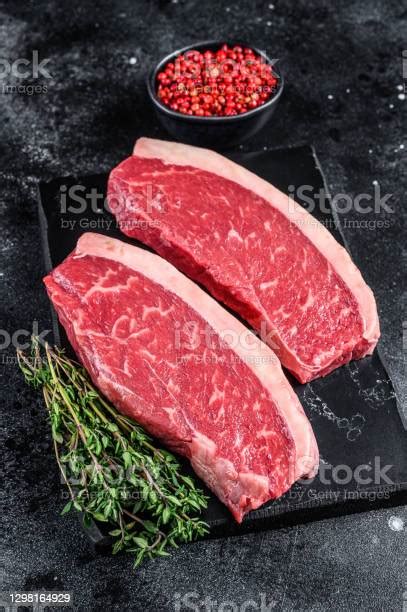 대리석 보드에 생 캡 럼프 스테이크 또는 상단 등심 쇠고기 고기 스테이크 검은 색 배경 위쪽 보기 0명에 대한 스톡 사진 및