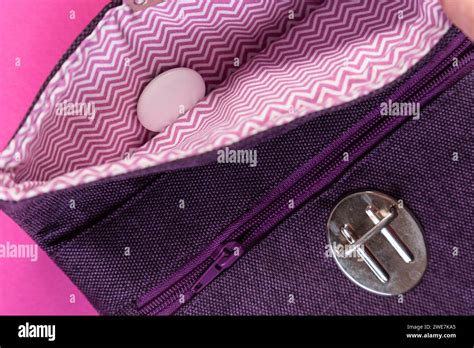 An Apple Air Tag Lies In A Purple Clutch Against A Plain Pink Background Stock Photo Alamy