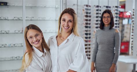 흰 셔츠를 입은 딸과 함께 다른 안경을 쓰고 스탠드 앞에 서 있는 어머니와 실내 방에 있는 또 다른 웃는 여자 사진 Unsplash의 건강한 라이프 스타일 이미지