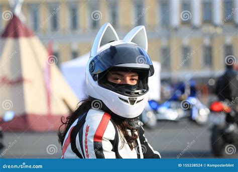 Female Motorbiker In An Anime Cat Helmet Looking At The Camera