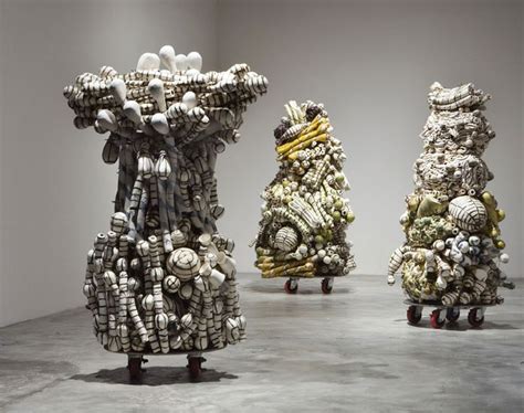 Three Sculptures Made Out Of Different Types Of Objects