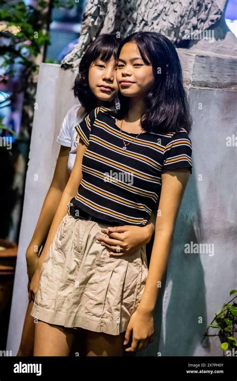 Two Young Filipino Girlfriends Hug Outside Santo Nino De Tondo Church