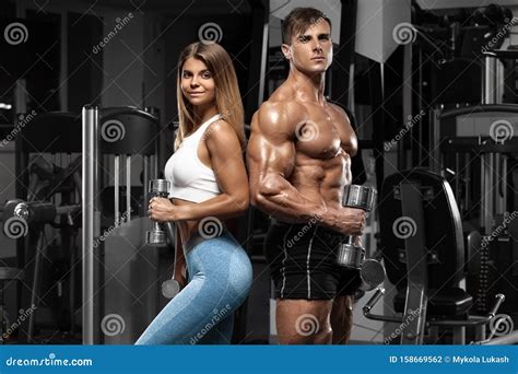 Sporty Couple Showing Muscle And Workout In Gym Muscular Man And Woman