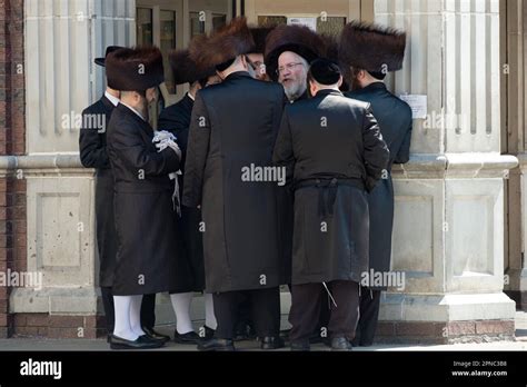 Orthodox Jewish Men From The Satmar Group Crowd Around A Speaker