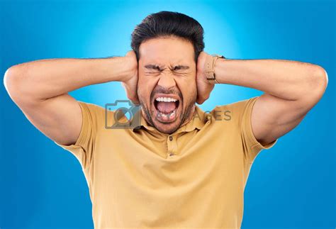 Man Covering His Ears While Screaming In A Studio For Angry Upset Or