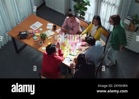 Close Up Of Professional Business Team Hands Writing And Putting Sticky