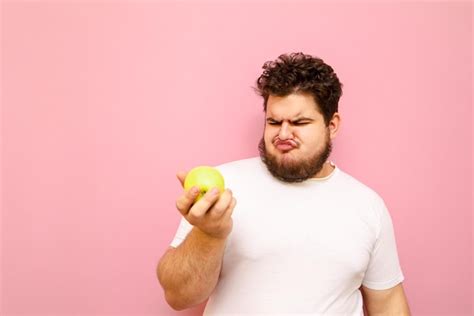 Premium Photo Funny Fat Man With An Apple In His Hand And Looking