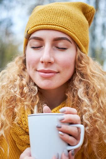 Redhead Curly Cheerful Cute Girl Siting In Autumn Park And Holding