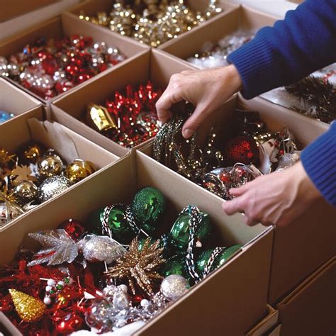 A Person Sorting And Organizing Seasonal Decorations In Labeled Storage