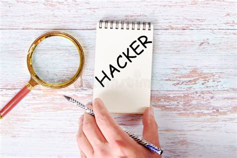 Hacker Word On A Notebook In A Man S Hand With A Pencil And A