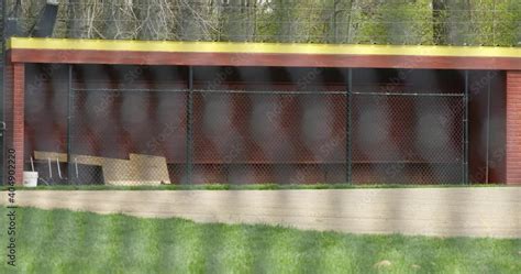 Empty No People at School Baseball Field and Sports Team Dugout with Bleachers Looking Through a ...