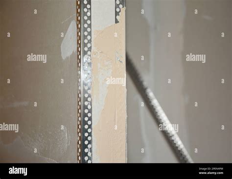 Drywall Partition Construction Close Up On Skim Coating Finishing