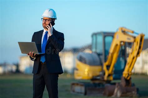 Architect At A Construction Site Architect Man In Suit And Helmet At Construction Site Stock