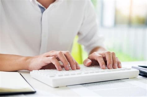 Premium Photo Midsection Of Businessman Typing On Keyboard At Desk In