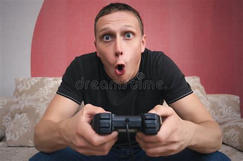 Excited Girl Gamer Sitting At The Table Playing Online Games Stock