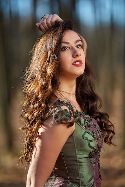 Premium Photo Closeup Portrait Of A Beautiful Young Brunette In Green