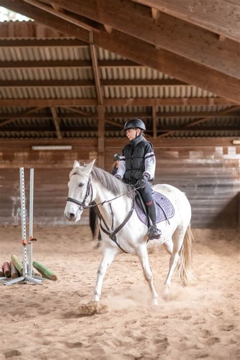 Beautiful Young Girl On Her White Pony During Her Riding Lesson Stock