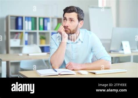 Bored Sleepy Office Worker Sitting At Work Workplace At Computer Desk Leaning On Hand Yawning