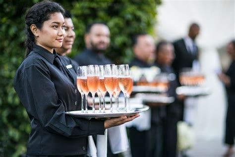 Cocktail Hour Servers Ready To Serve Champagne And Rose Served On