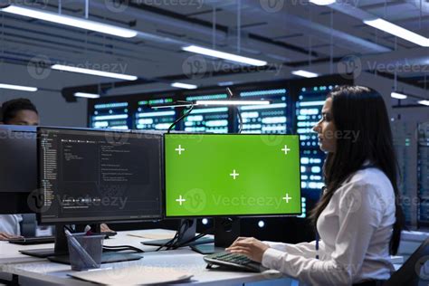 Coworkers In Data Center Checking Equipment Performance On Green Screen