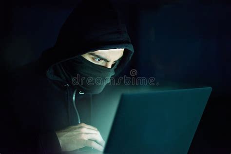 Man Laptop And Hoodie On Black Background For Hacking Phishing And