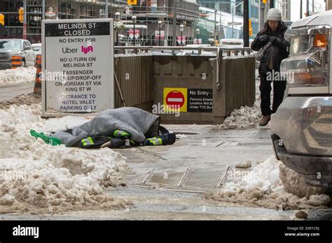 Toronto Canada 14th Feb 2025 A Homeless Man Sleeps On A Slushy Grate