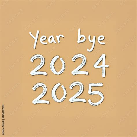 message year 2024 replaced by 2025 text written on beach sand