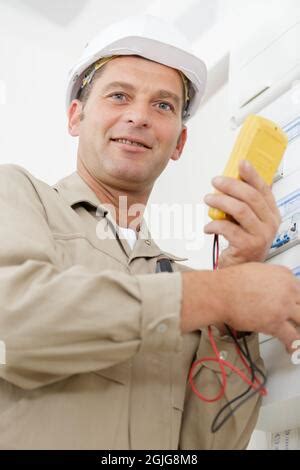 Electrician Measuring Voltage In Distribution Board Stock Photo Alamy