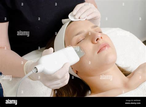 Beautiful Woman Receiving Ultrasonic Facial Exfoliation Procedure Of Ultrasonic Cleaning Of Face