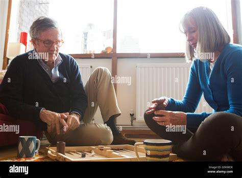 Couple Playing Backgammon On Floor Stock Photo Alamy