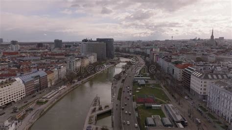 Aerial Footage Of Multistorey Buildings Along River In City Vehicles