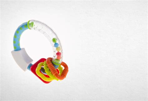 Premium Photo Close Up Of Colorful Teething Ring Against White Background