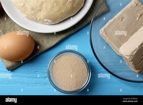 Different Types Of Yeast Egg And Dough On Light Blue Wooden Table Flat Lay Stock Photo Alamy