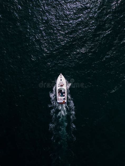Aerial View Of A Pleasure Boat Racing Through The Sea Waves Creating A